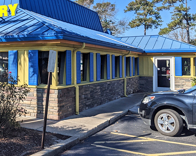 The sunshine-yellow exterior with that unmistakable blue roof isn't just a building—it's a morning beacon of breakfast possibilities waiting to happen.