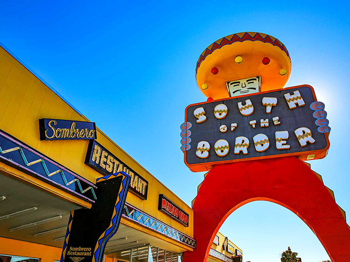 The iconic sombrero-topped observation tower stands like a technicolor sentinel, announcing "normal travel experiences end here!" It's visible for miles along I-95.