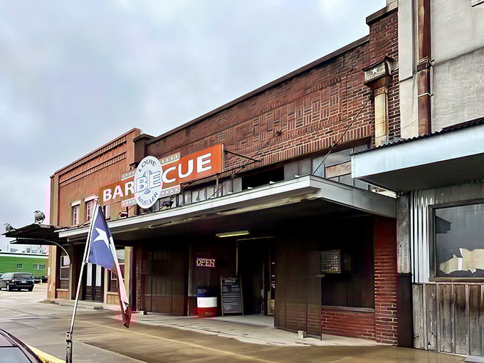 The unassuming brick exterior of Louie Mueller Barbecue – where culinary pilgrimages begin and diets go to die gloriously.