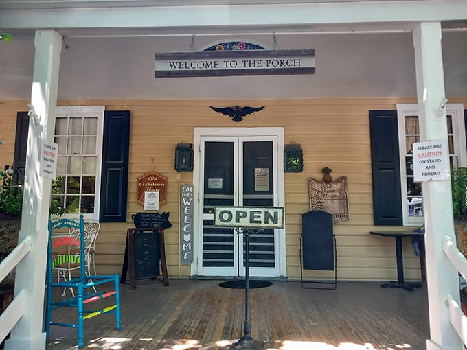 The porch says "Welcome" and means it. That bright blue rocking chair isn't just furniture—it's an invitation to slow down and savor what's coming.