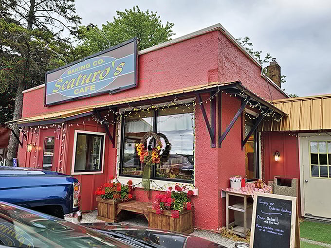 The cherry-red exterior of Scaturo's welcomes visitors like a warm hug, complete with colorful picnic tables and flower boxes that scream "Sit! Eat! Stay awhile!"