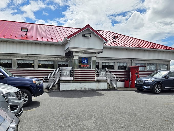 The classic red-roofed diner stands like a time capsule in Plains, Pennsylvania – a beacon of breakfast hope for hungry travelers and locals alike.