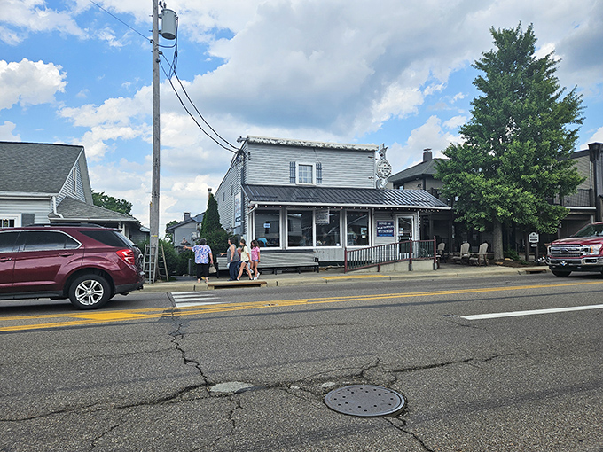 Where horse-drawn buggies meet hungry travelers, this unassuming white clapboard building houses fried chicken that would make your grandmother jealous.