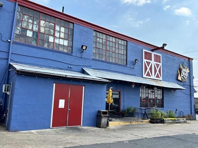 The blue barn-like exterior with its distinctive red trim isn't just eye-catching—it's a smoke signal to BBQ lovers that authentic goodness awaits inside.