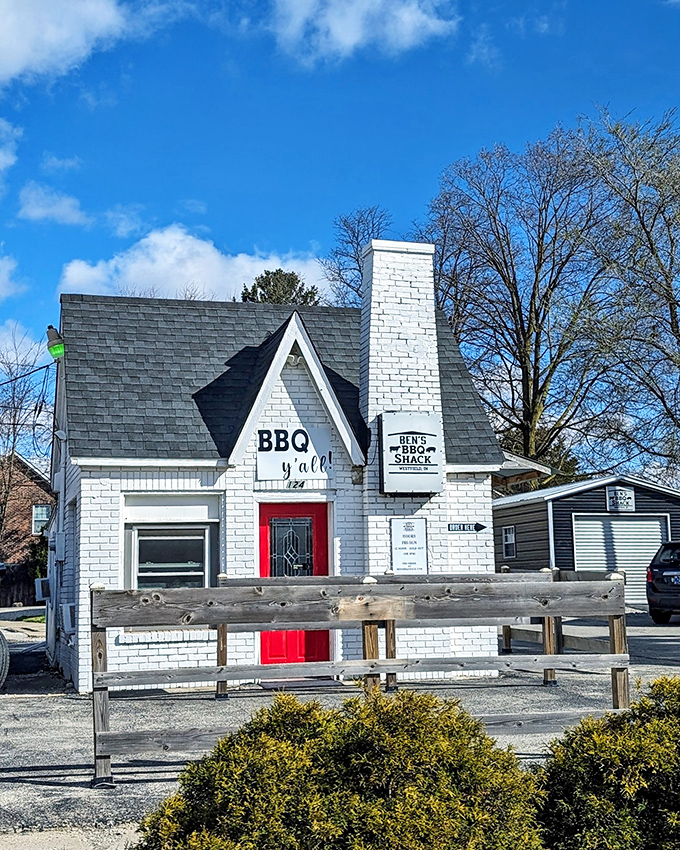The little white brick house with the red door isn't just charming—it's BBQ headquarters. That "BBQ y'all" sign is basically Indiana's version of the pearly gates.