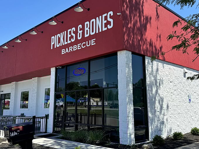 The bright red exterior of Pickles & Bones stands like a beacon of barbecue hope in Milford, promising smoky delights within those unassuming walls.