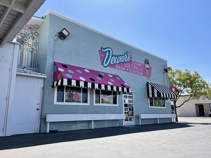 The mint-green facade with polka-dotted awnings isn't just eye-catching—it's a portal to your childhood sweet tooth memories.