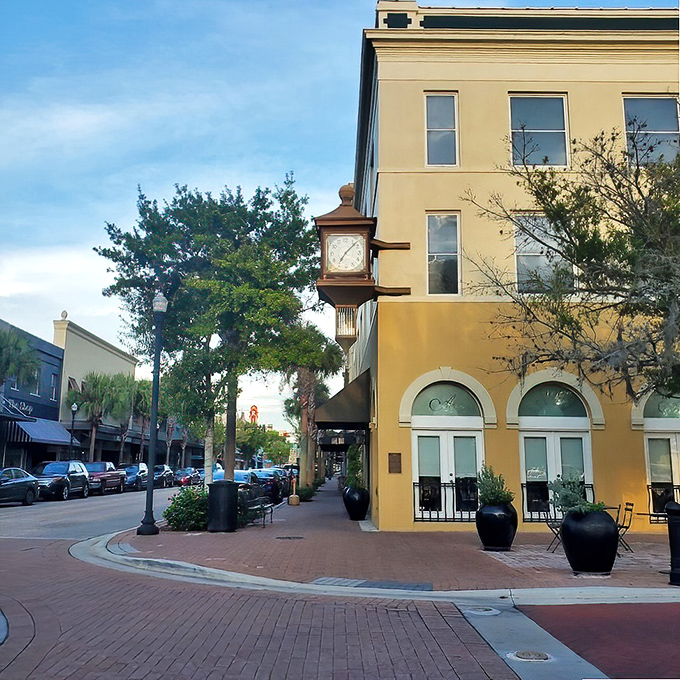 The golden façade and royal blue awning of Arabellas isn't just a restaurant entrance—it's a portal to Italy hiding in plain sight on Winter Haven's brick-lined streets.