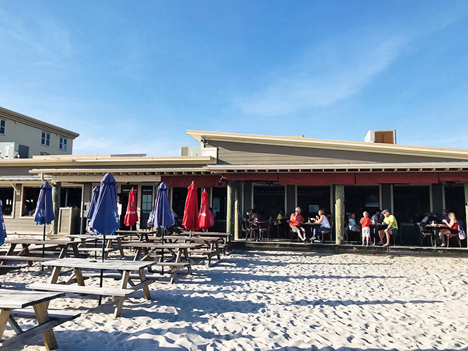Paradise doesn't need fancy architecture—just a weathered wooden deck, sugar-white sand beneath, and the promise of seafood that was swimming this morning.