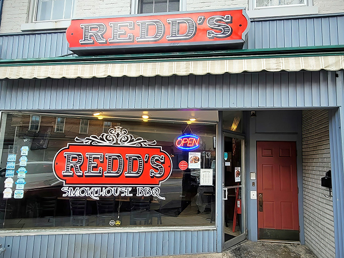 The bright red Redd's sign beckons like a barbecue lighthouse on Carlisle's West High Street, promising smoky salvation to all who enter.
