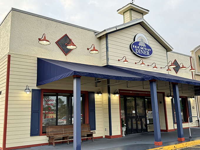 The welcoming facade of Broadway Diner in Bartow beckons with its classic blue awning and warm lighting—like a culinary lighthouse for hungry travelers.