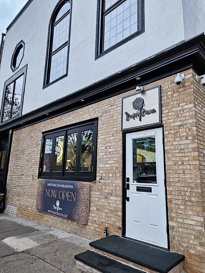 The unassuming brick exterior hides Philadelphia's pork paradise like a culinary speakeasy. Those planters aren't just pretty—they're guarding the gateway to flavor town.