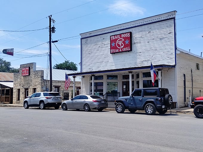 The neon-outlined Trail Boss sign glows like a beacon for hungry travelers. This unassuming exterior houses culinary treasures that would make any cowboy weep with joy.