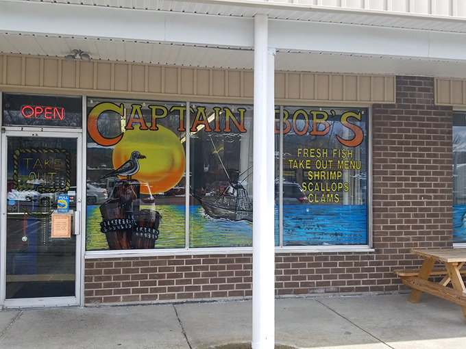 The unassuming exterior of Captain Bob's belies the seafood treasures within. Strip mall location, maritime signage, and the promise of both eat-in and take-out options.