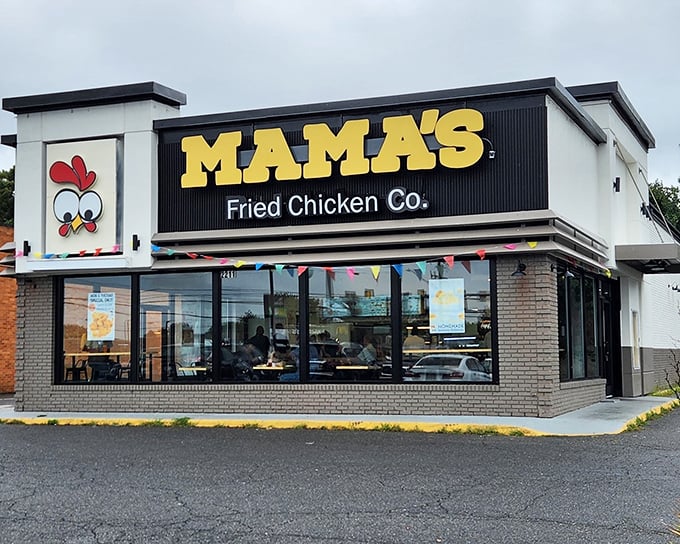 The unmistakable yellow sign beckons like a lighthouse for the hungry. Mama's cartoon chicken mascot practically winks at you, promising crispy delights inside.