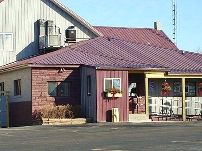 The unassuming exterior of Antlers Supper Club in Bonduel invites you in with its decorative deer statues—a perfect preview of the Northwoods charm waiting inside.