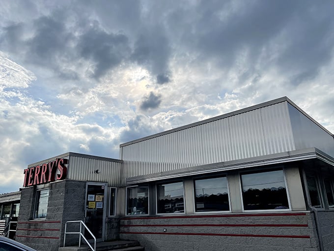 The classic stainless steel exterior of Terry's Diner gleams like a time machine to the golden age of roadside Americana. Those vintage soda machines aren't just for show!