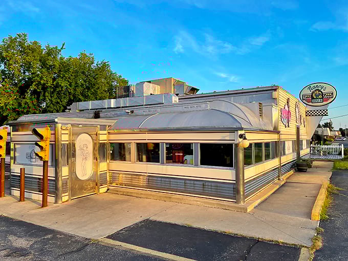 The classic stainless steel exterior of Nancy's Main Street Diner gleams in the sunlight, a time capsule of Americana waiting to feed hungry souls. 