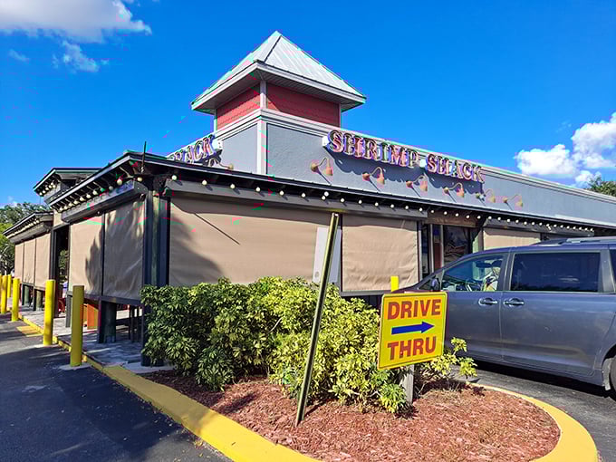 The iconic red and white exterior of Shrimp Shack stands like a beacon of seafood salvation in Fort Myers. No pretension, just a promise of deliciousness awaiting inside.