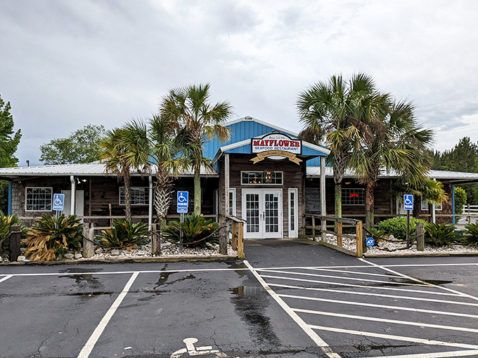 The blue-roofed Mayflower Seafood Restaurant stands like a coastal oasis in Darlington, palm trees welcoming hungry travelers to seafood paradise.