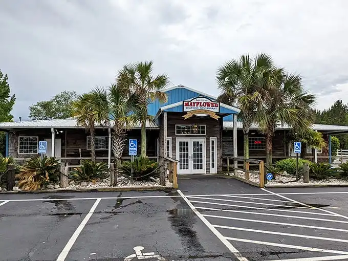 The blue-roofed Mayflower Seafood Restaurant stands like a coastal oasis in Darlington, palm trees welcoming hungry travelers to seafood paradise.