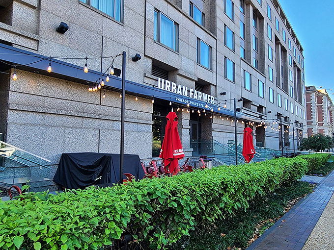 The modern façade beckons with its clean lines and warm string lights—Philadelphia's steakhouse revolution hiding in plain sight.