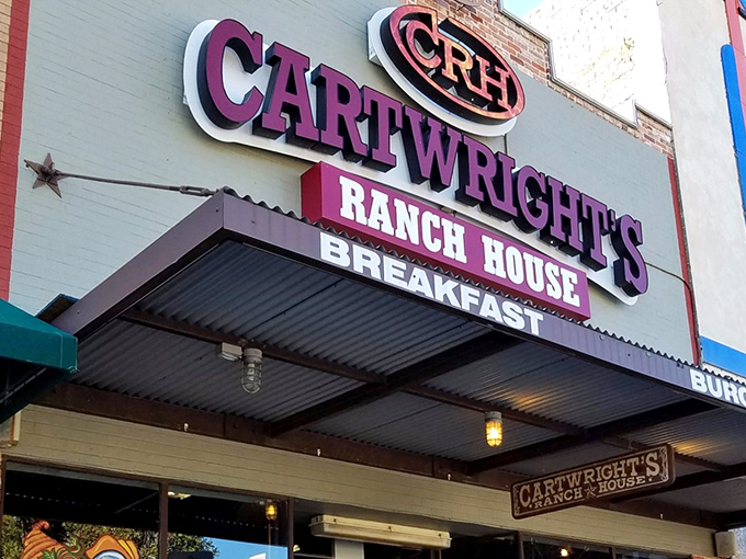 The purple sign beckons like a Texas-sized promise – Cartwright's Ranch House isn't just a restaurant, it's a declaration of comfort food devotion.