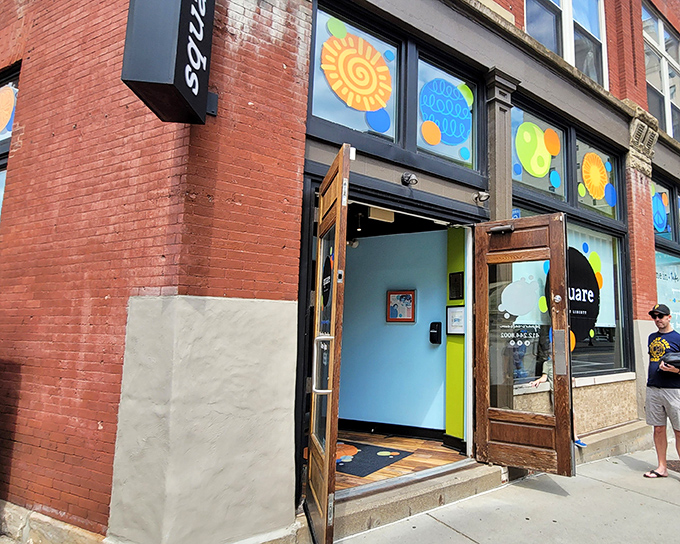 The bright orange sign and blue door of Square Cafe stand out like a breakfast beacon on Pittsburgh's East End, promising pancake perfection within.