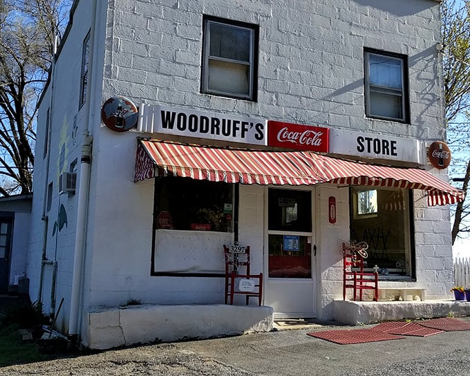 The classic white brick exterior of Woodruff's, with its vintage Coca-Cola sign and red-striped awning, isn't trying to impress anyone—it doesn't need to.