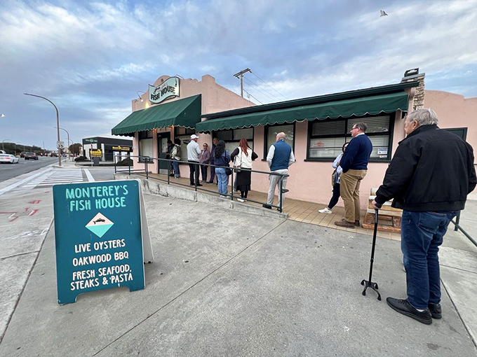 The unassuming pink exterior with a line already forming – proof that the best seafood spots don't need fancy facades, just fantastic food.
