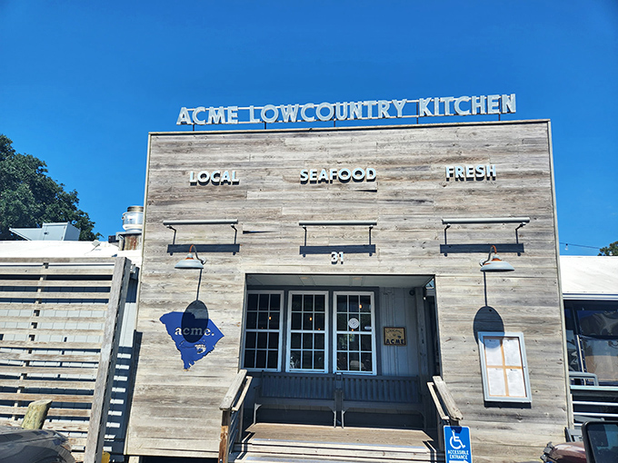 The weathered wooden facade of Acme Lowcountry Kitchen promises exactly what the sign delivers: local, fresh seafood without pretense or fuss.