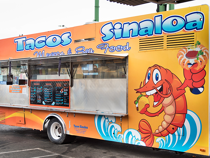 The vibrant orange truck with its cartoon shrimp mascot stands like a beacon of taco hope on International Boulevard. Street food paradise found!