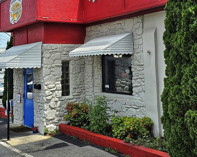 The red and blue exterior of Gabby's stands like a colorful beacon for burger enthusiasts. No fancy architecture needed when what's inside tastes this good.