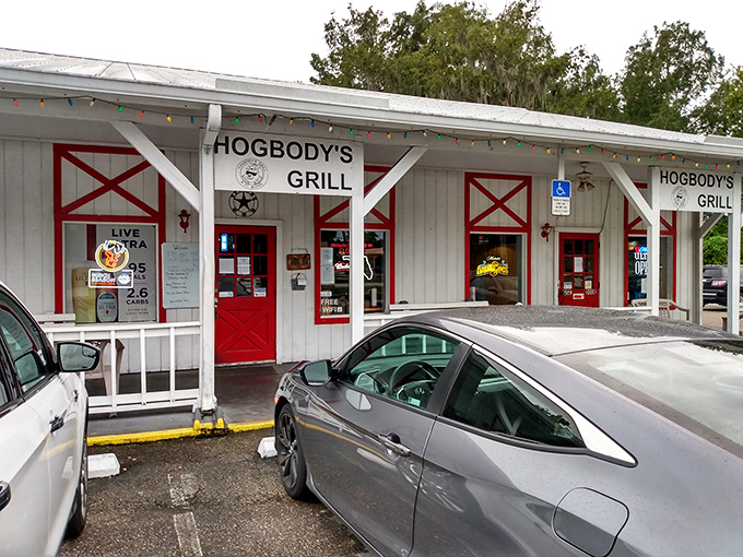 The barn-inspired exterior of Hogbody's, with its distinctive red doors and white clapboard, promises authentic flavors hiding behind that unassuming façade.