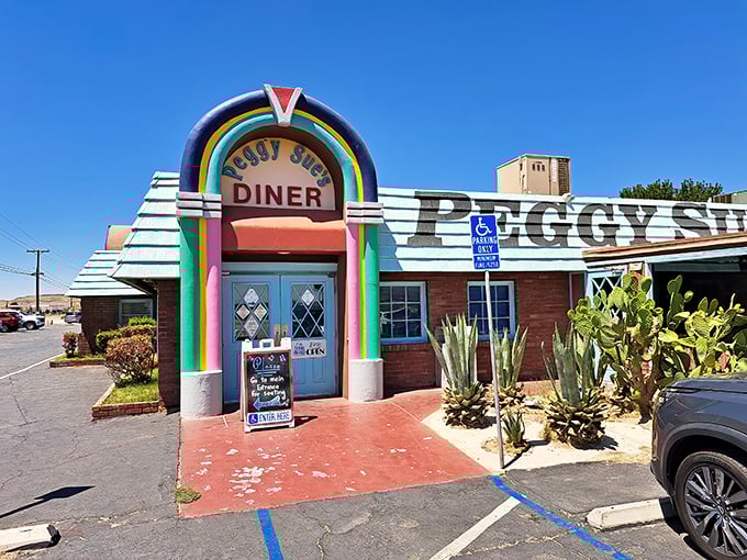Like a rainbow-colored mirage in the desert, Peggy Sue's 50's Diner stands proudly against the Mojave sky, promising nostalgic delights to weary travelers.