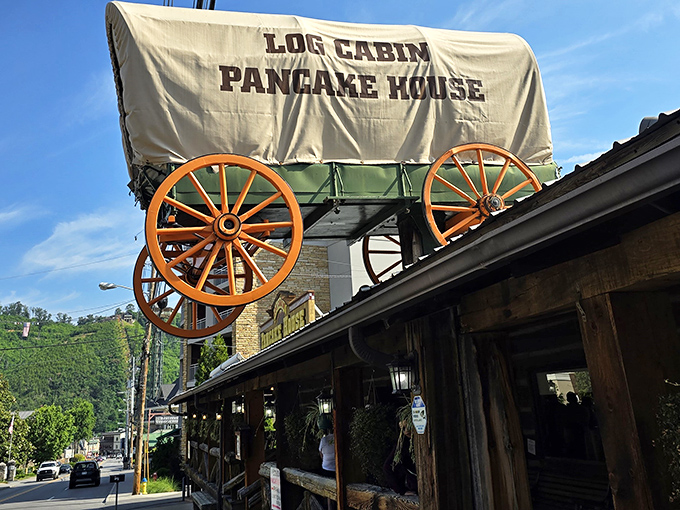 That covered wagon on the roof isn't just decoration—it's a beacon calling hungry travelers to breakfast paradise in the Smokies.