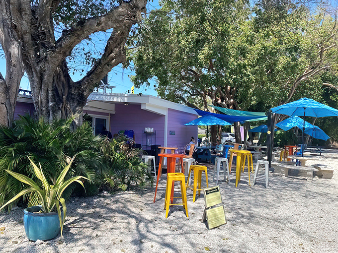The sunshine-yellow exterior with its purple sign isn't just eye-catching—it's practically screaming "vacation mode activated" to everyone driving by.