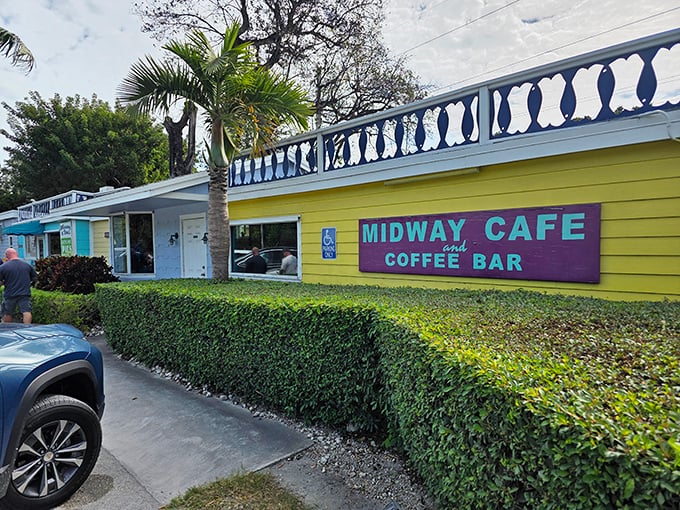 The sunshine-yellow exterior with its purple sign isn't just eye-catching—it's practically screaming "vacation mode activated" to everyone driving by.
