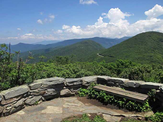 Layer upon layer of blue-tinged mountains stretch to the horizon, with nature's own stone wall providing the perfect foreground for your "I'm on top of the world" moment.