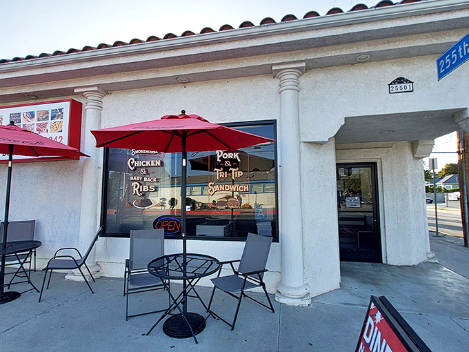 The unassuming storefront that launches a thousand road trips. Red umbrellas beckon like BBQ sirens calling you home.