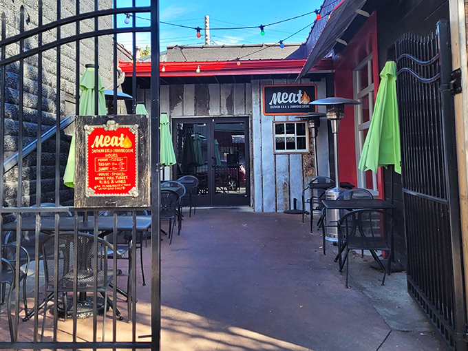The entrance to Meat BBQ beckons like a smoky siren call, with rustic charm and that red sign promising delicious things ahead.