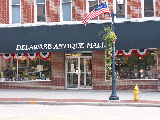 The iconic burgundy awning of Delaware Antique Mall beckons treasure hunters into this historic brick building, where the past awaits rediscovery.