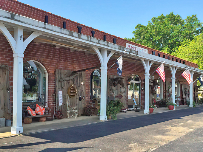 The brick façade with white columns isn't just charming—it's a time portal disguised as architecture. American flags flutter like welcome banners to treasure hunters.