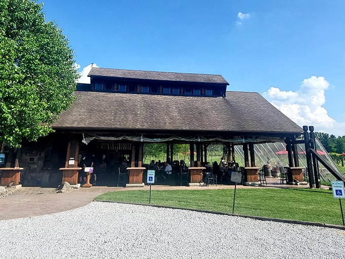 The rustic barn exterior of Sarah's Vineyard welcomes visitors with its weathered wood charm and inviting outdoor seating—Napa Valley spirit with heartland hospitality.