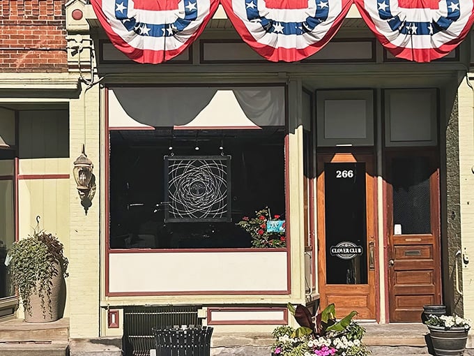 The patriotic bunting above Clover Club's storefront isn't just decoration—it's a promise that inside awaits the kind of all-American comfort food that makes you salute your sandwich.