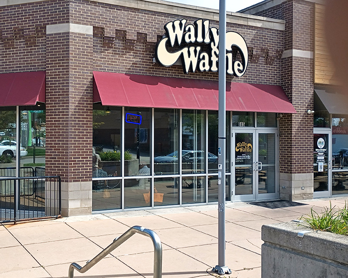 The iconic yellow Wally Waffle sign beckons breakfast enthusiasts like a lighthouse guiding hungry sailors to the shores of deliciousness