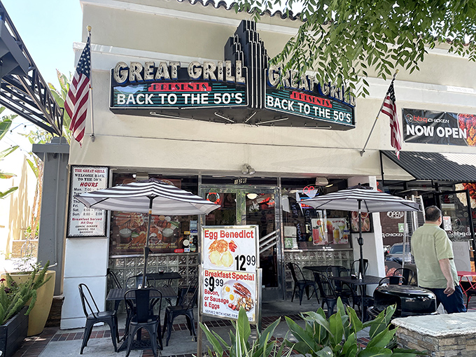The iconic façade of The Great Grill beckons with its neon promise of time travel. American flags flutter alongside a menu that makes decisions deliciously difficult.