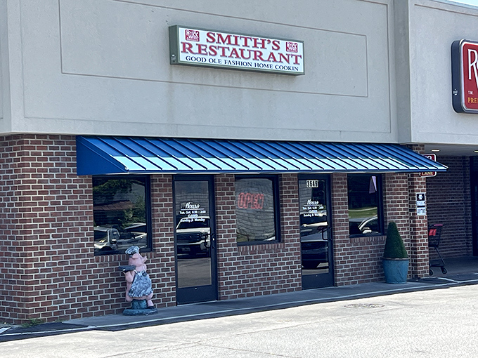 The unassuming brick façade with its bright blue awning promises no frills, just honest-to-goodness Southern cooking that's worth every calorie.