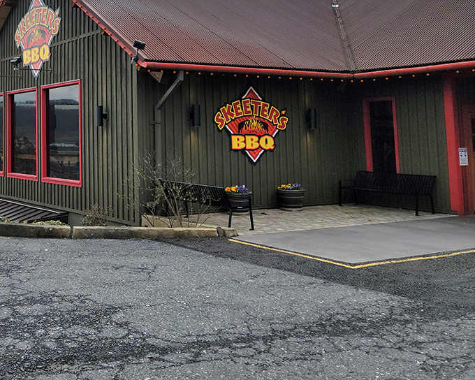 The green exterior with red trim of Skeeter's BBQ isn't trying to impress anyone—it's saving all that energy for what happens inside those smokers.
