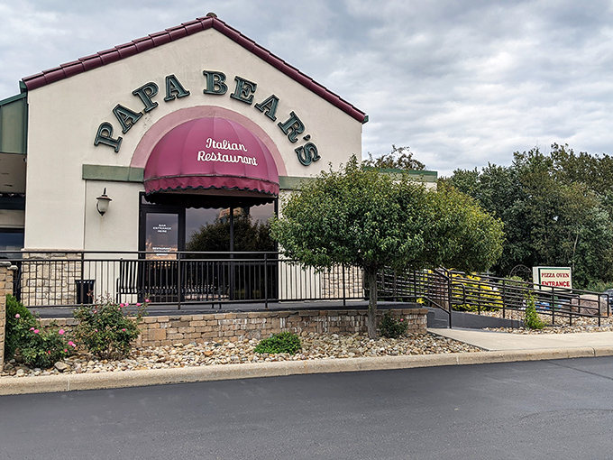The welcoming facade of Papa Bear's Italian Restaurant in North Canton beckons with its distinctive burgundy awning and stone accents—like a warm Italian hug in building form.